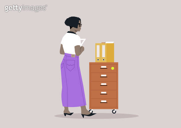 Employee Organizing Files in a Modern Office Setting, A person stands ...