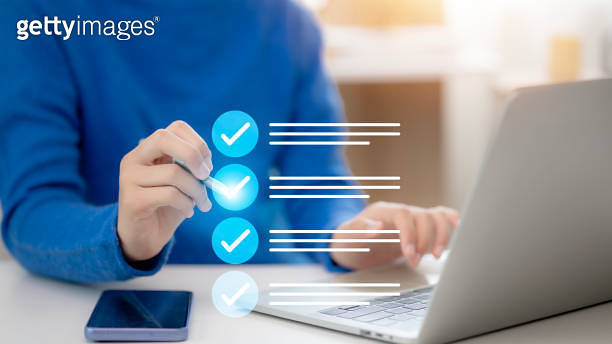Women touching a virtual screen to tick mark documents for online ...