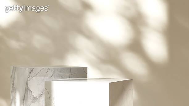 Two modern marble white cuboid table podium in sunlight on beige wall ...