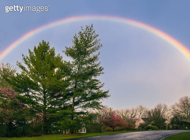 Beautiful view of rainbow over suburban Midwestern street in early ...