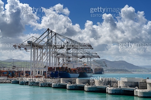 container ships being unloaded and loaded at Tanger Med port in Morocco ...