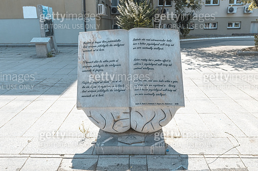 Stone monument in the shape of book and brain on the street of Pristina ...