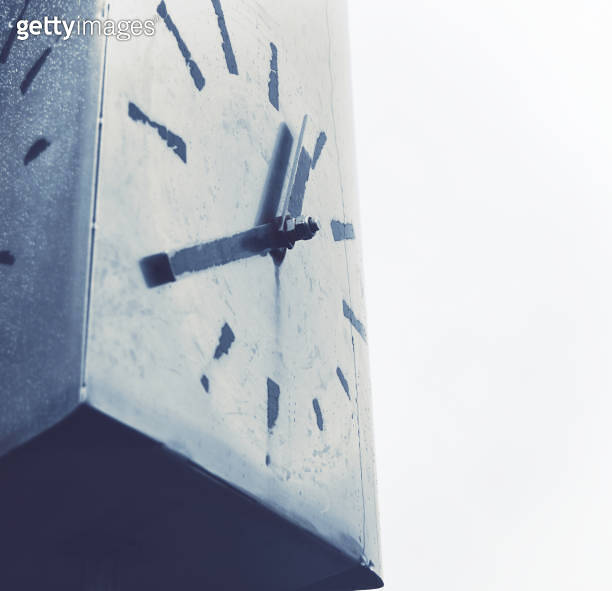 Old weathered rusty faded scratched white clock with fading black ...