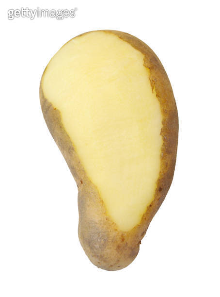 Vertical image of cut out of one raw staple carbohydrate food vegetable ...