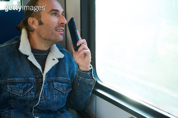 Caucasian handsome mid adult man traveler, commuter looking out the ...