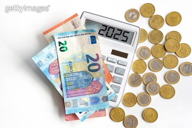White calculator shows the year 2025, with euro banknotes on it and ...