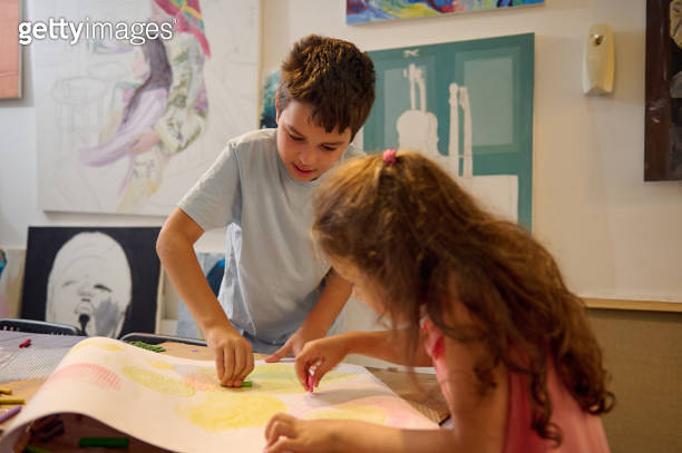 Caucasian inspired kids learning art, drawing with pencils in workshop ...