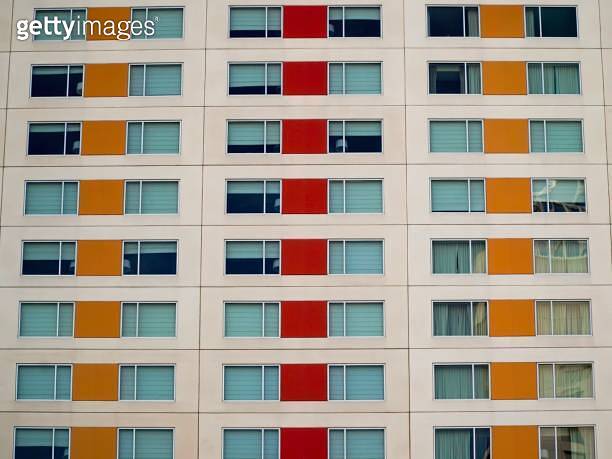 Alternating yellow and red squares on three columns of windows of an ...