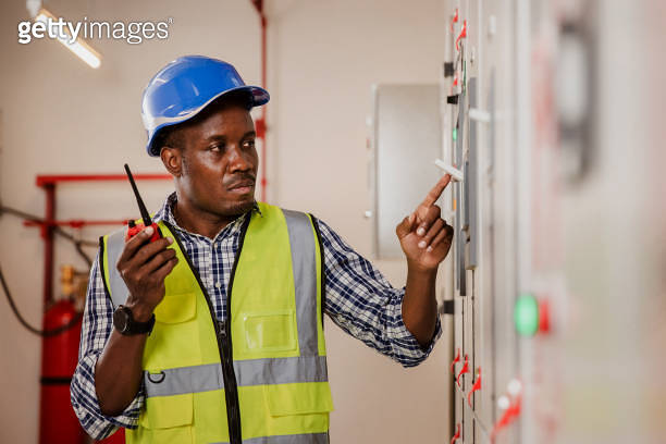 Electrical engineer working in control room. Electrical engineer man ...