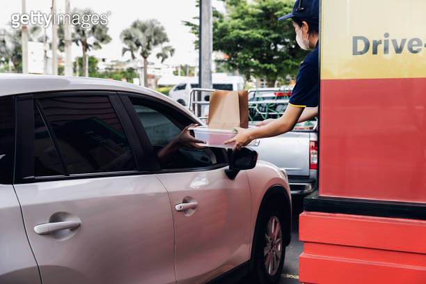 Hand Man in car receiving coffee in drive thru fast food restaurant ...