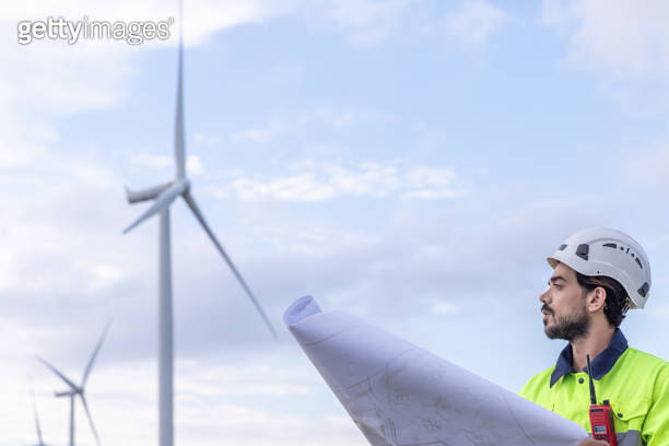 Professional Man Maintenance engineers working in wind turbine farm at ...