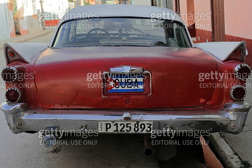 Red-maroon white almendron car -Dodge classic from 1958- stopped among ...