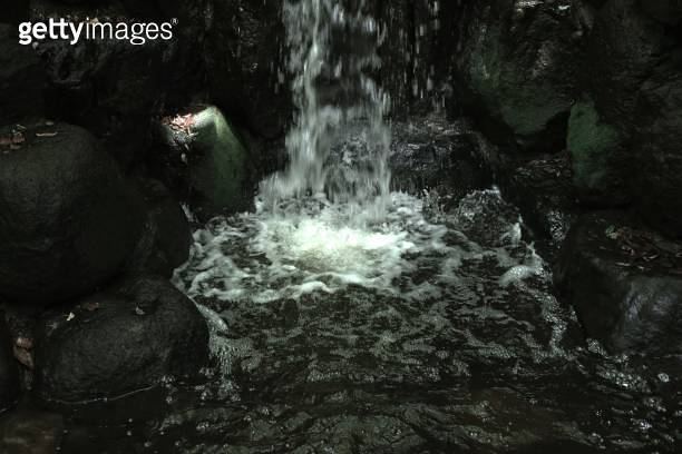 Scenery of water flowing from a small waterfall. Waterfall background ...