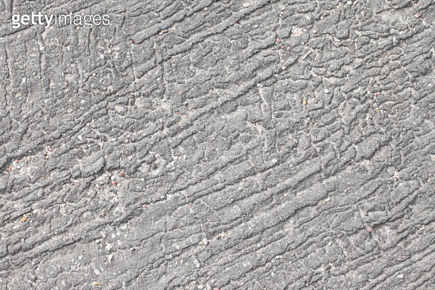 Melt asphalt crumpled. Wrinkled surface. Destroyed road texture ...