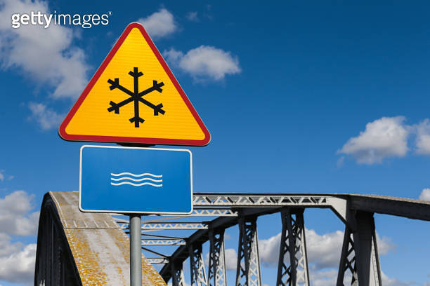 Road sign before a steel bridge, warning of river crossing and ...