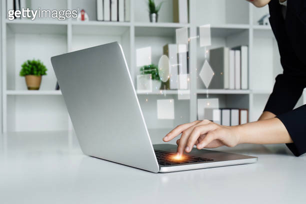 Business woman using a computer analysis for process and workflow automation with flowchart, a ...