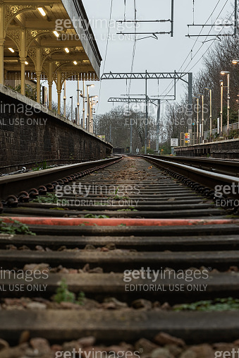 Railway iron rails from the low perspective. Railroad tracks with ...