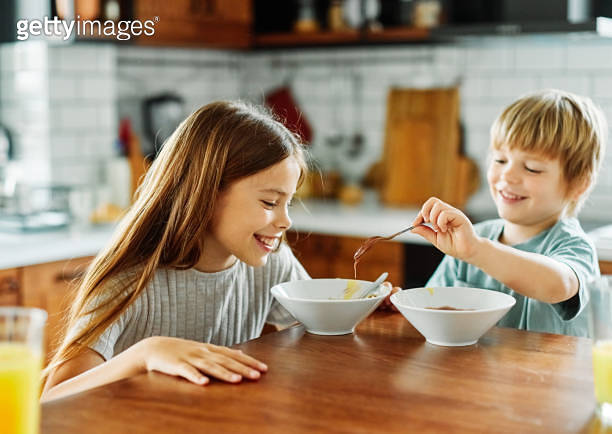 child girl boy eating kid brother sister food breakfast kitchen ...