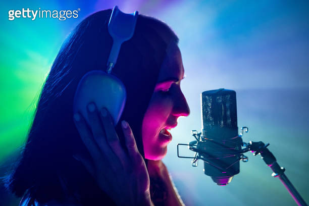 Intense performance. Side view portrait of female talented singer and ...