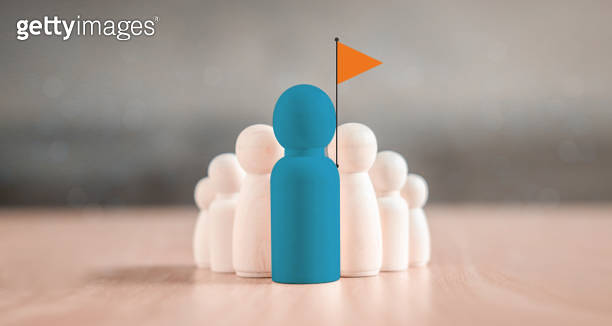 Wooden figure standing on a cube higher than others - concept of ...