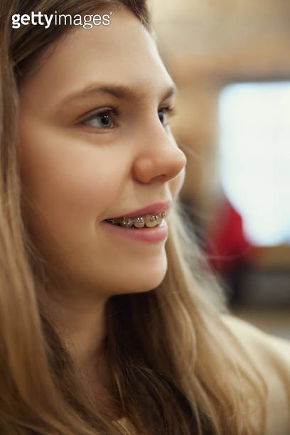 Close up profile portrait of young cute girl smiling with teeth in ...