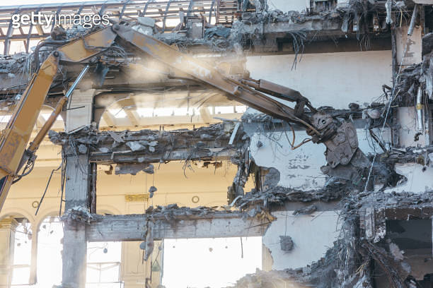 Photo of destroyed building, protruding reinforcement. Demolition of a ...