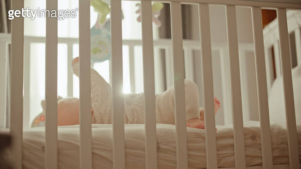 Playful Baby Boy Lying in White Crib By Window at Home 이미지 (2025394645 ...
