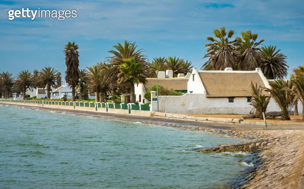 Palm tree lined promenade lining the lagoon in Walvis Bay, Namibia 이미지 ...