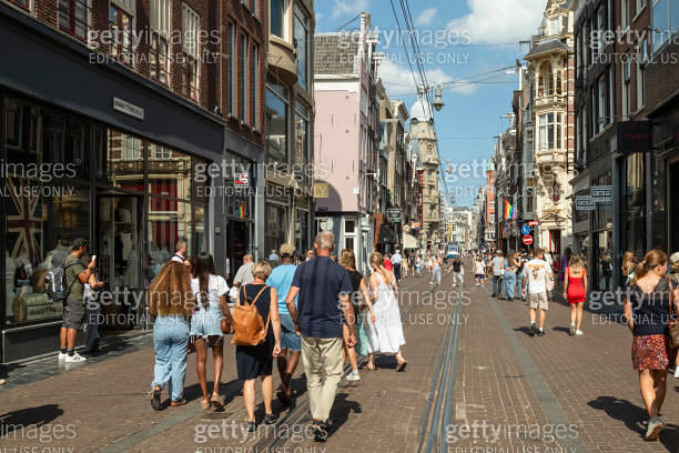 People walk through the popular shopping street - Leidsestraat, in the ...