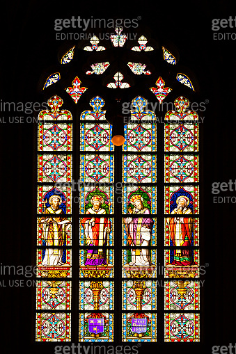 Stained glass window depicting a saint performing the sacrament of Holy ...