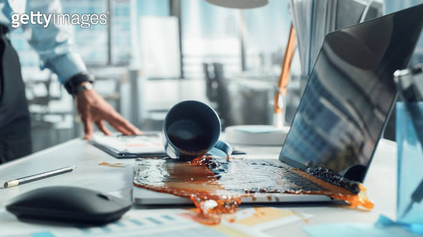 Clumsy Office Worker Accidentally Spilling Hot Coffee on Working Laptop ...