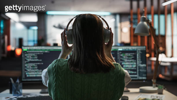 Creative Office: Professional Female Programmer Uses Headphones ...
