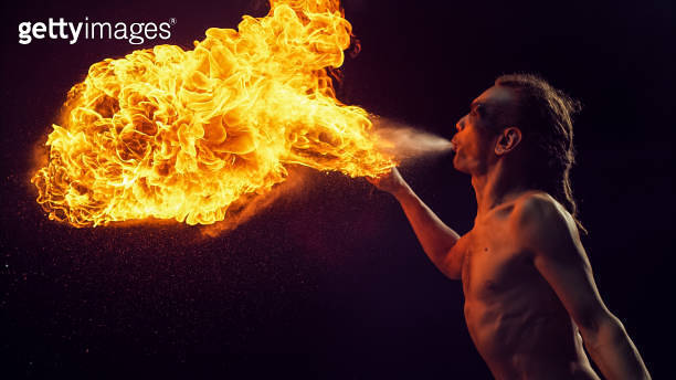 Shirtless Male Fire Performer With Dreadlocks Expertly Breathes Massive ...