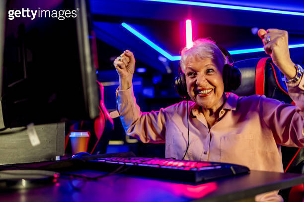 Senior Gamer Wearing Headphones and Playing Competitive Video Game 이미지 ...