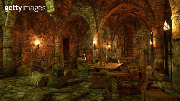 Grungy old medieval castle dungeon interior lit by burning torches and ...