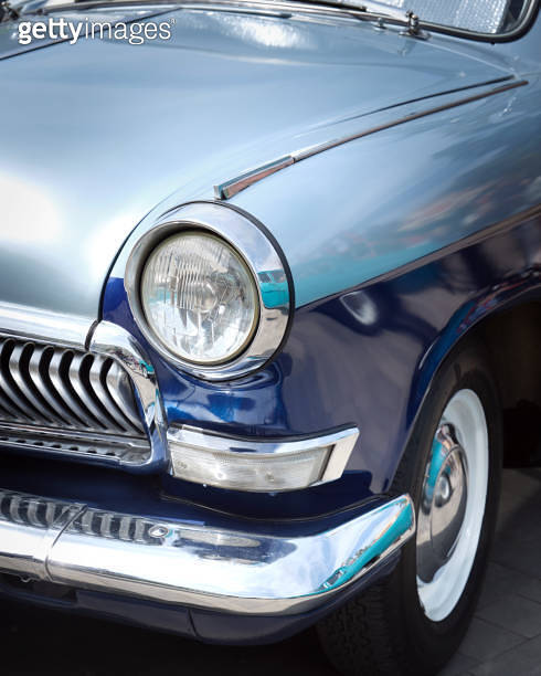 Close-up of the front of a beautiful blue car. Exhibition of retro cars ...
