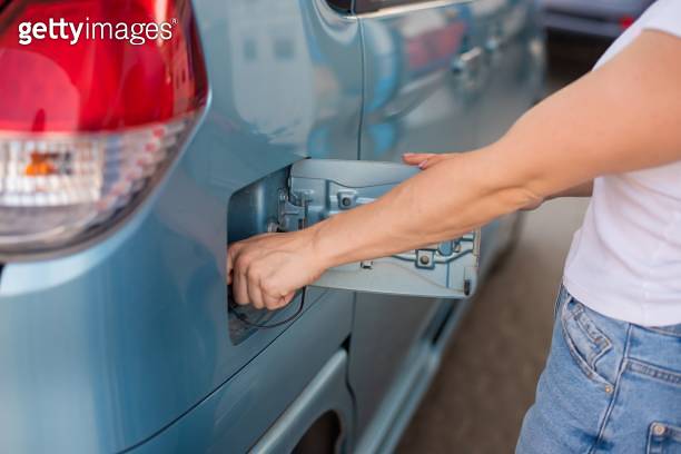 Woman refueling car with gasoline at self-service gas station. 이미지 ...