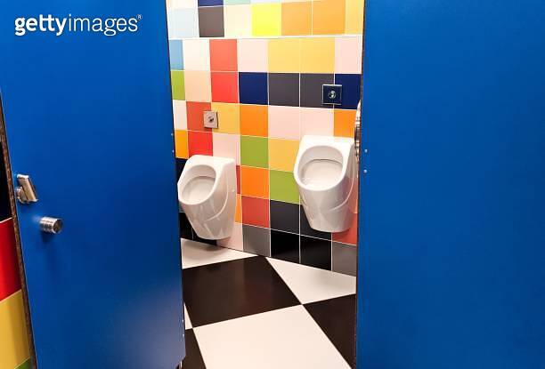 Shared family bright restroom with two pisuars in shopping center, mall ...