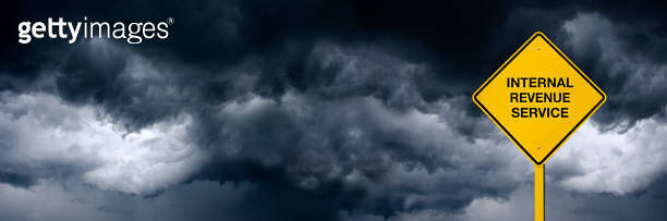 Caution Sign in Front of Storm Clouds Warning of Internal Revenue ...