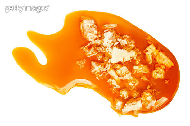 Salted Caramel sauce isolated on white. Salty milk caramel smear with ...