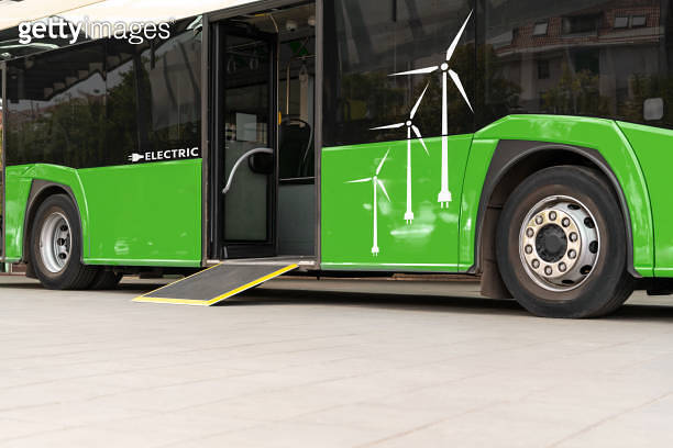 Green coloured electric bus powered by renewable energy with logos of ...