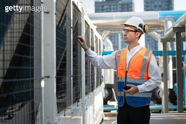Asia Man engineer using notebook computer working at rooftop building construction or working ...
