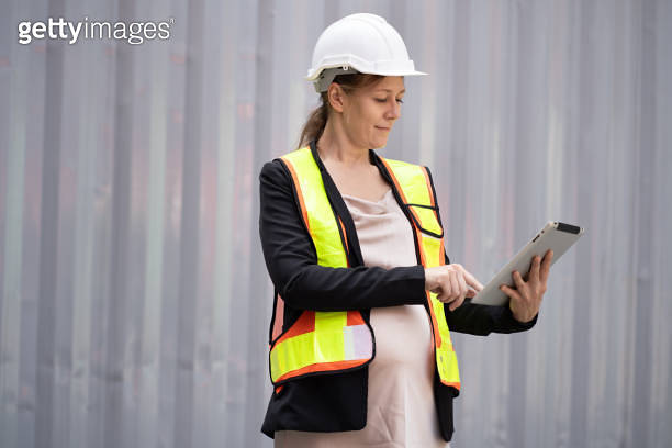 Portrait Happy caucasian logistic engineer pregnant woman working with ...
