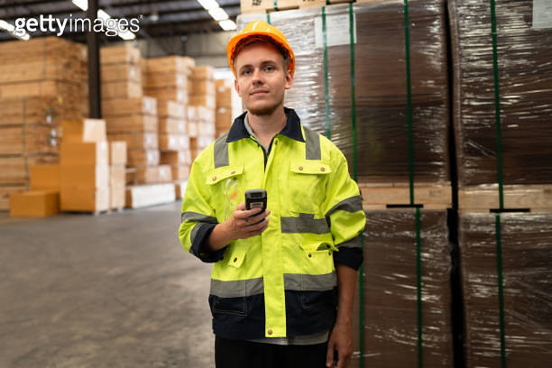 Portrait Caucasian businessman checking timber stock with bar code ...