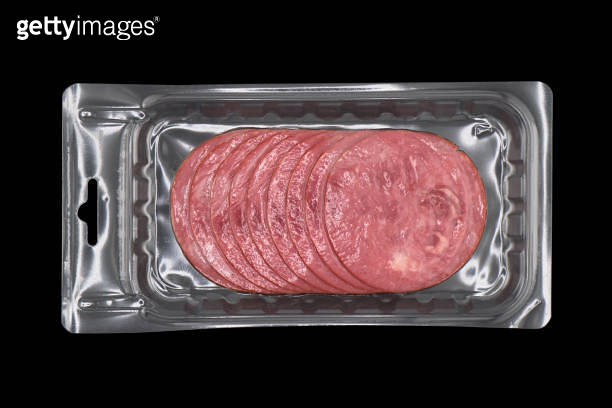 Sliced smoked beef meat in vacuum package isolated on black background ...