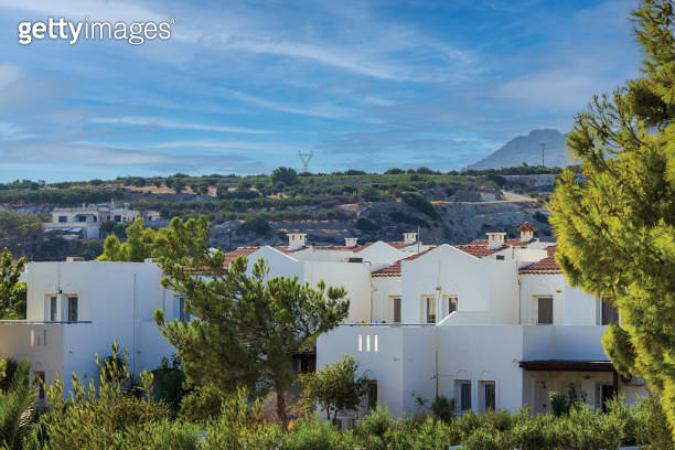 Beautiful view of white two-story hotel buildings with tropical garden ...