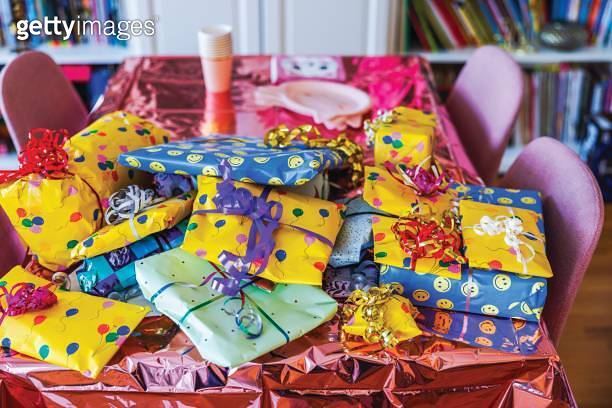 Close-up view of festive-wrapped children's gifts arranged on a table ...