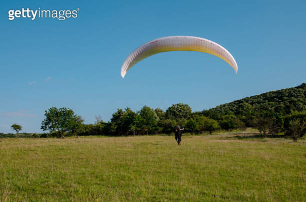 Man running high speed on field in nature ready to takeoff with ...