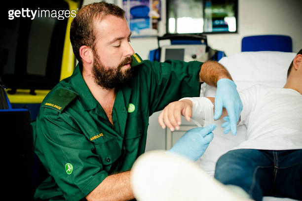 Paramedic giving a first aid to a young boy in an ambulance (2158189431 ...
