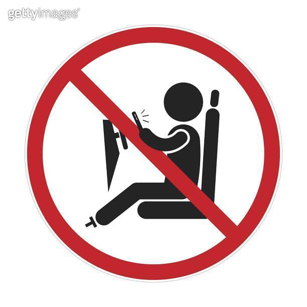 Isolated prohibition pictogram sign of man driving a car while using a ...